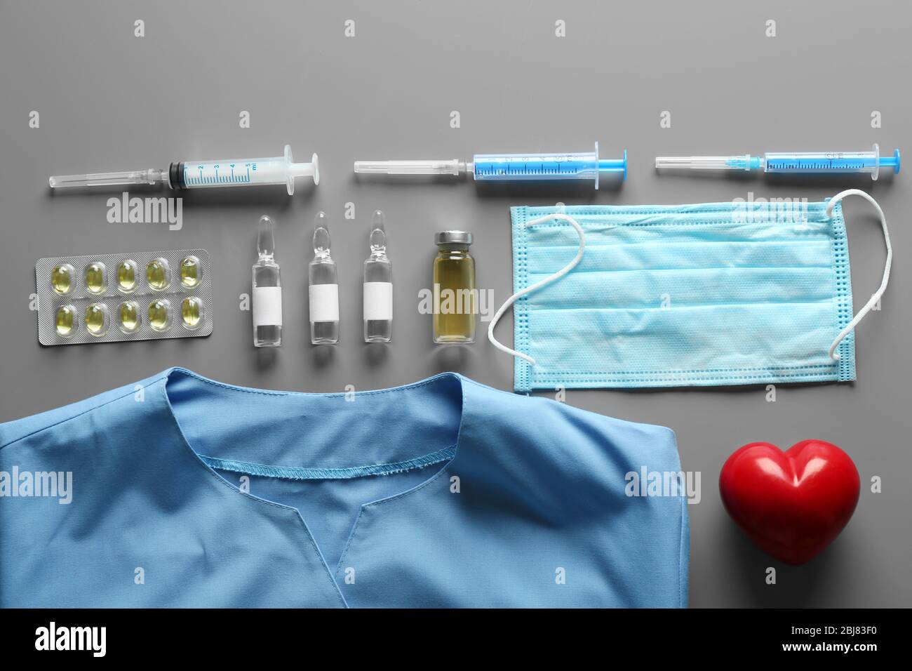 Doctor table with medicines and uniform, top view Stock Photo - Alamy