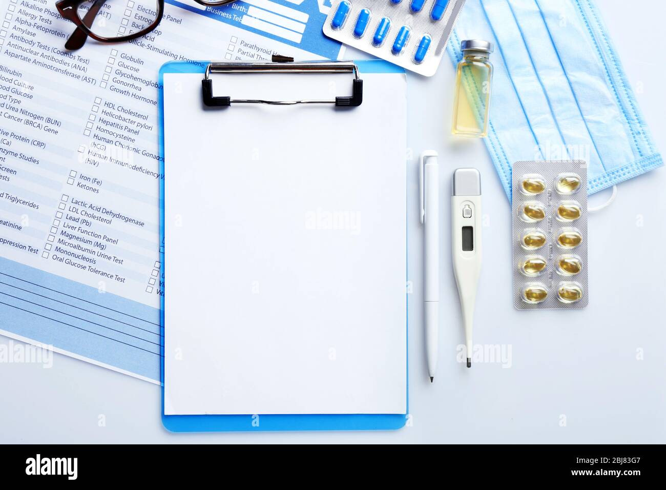 Doctor table with medicines and clipboard, top view Stock Photo - Alamy