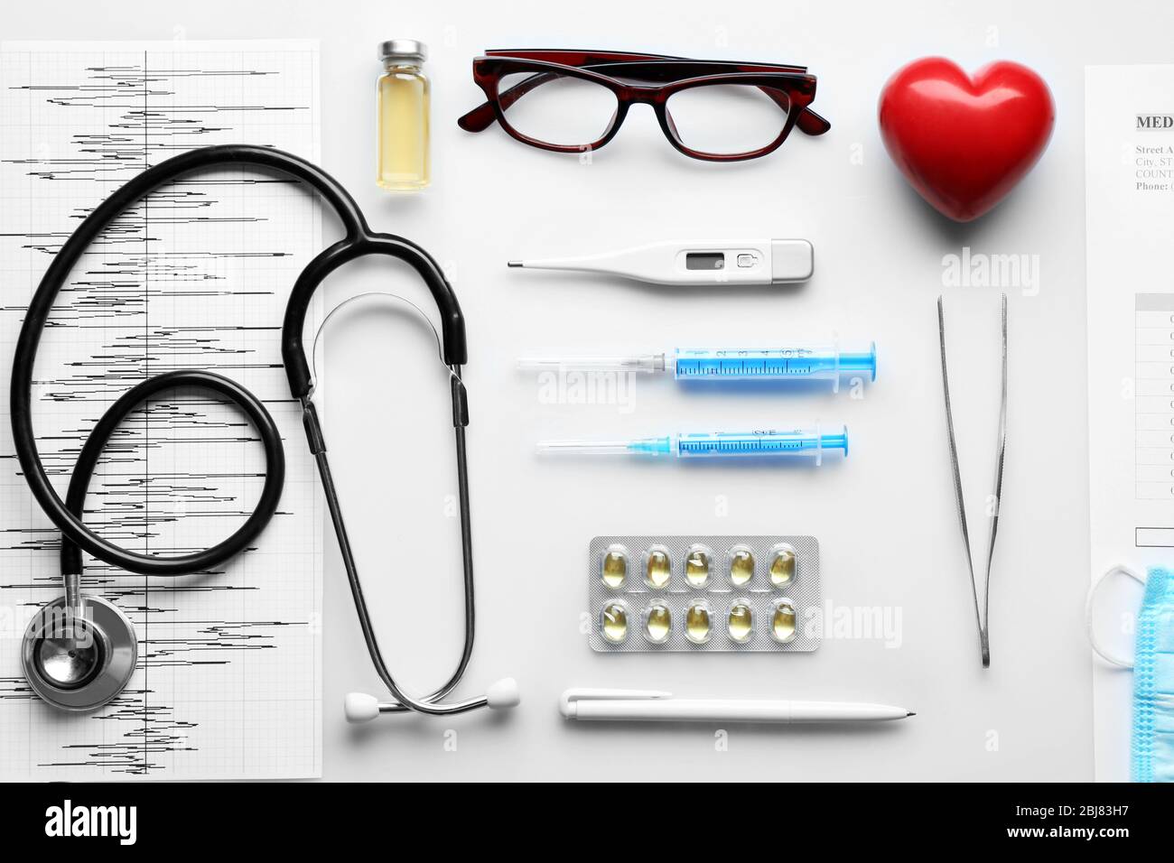 Doctor table with medicines, stethoscope and glasses, top view Stock ...