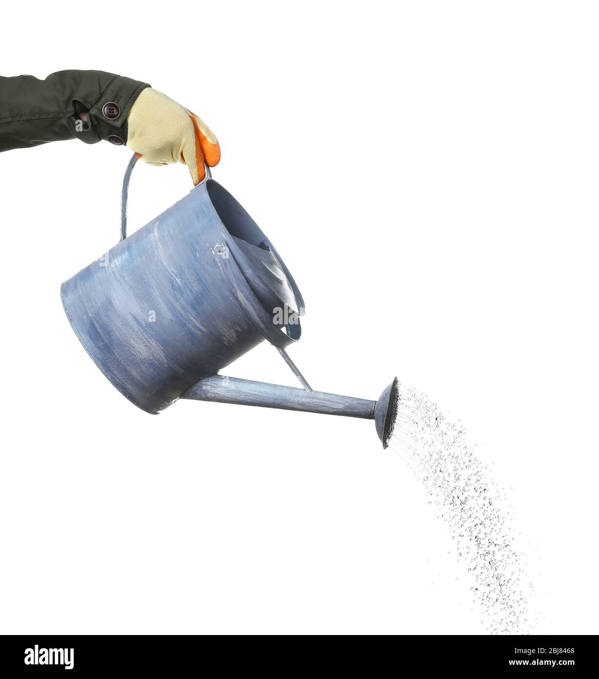 Hand pouring from metal watering can, isolated on white Stock Photo - Alamy