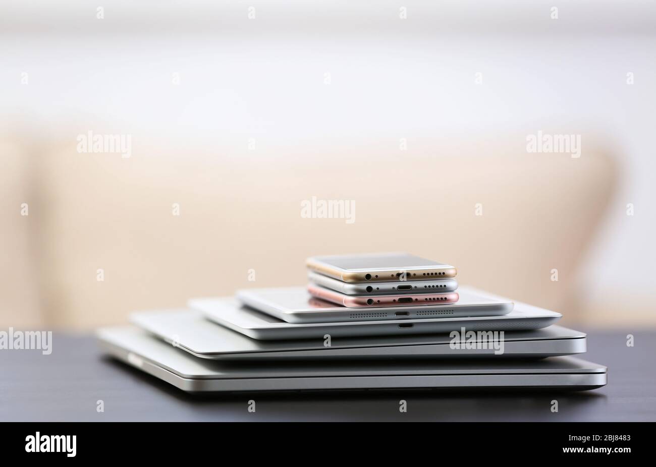 Stack of electronic devices on a dark desk Stock Photo - Alamy