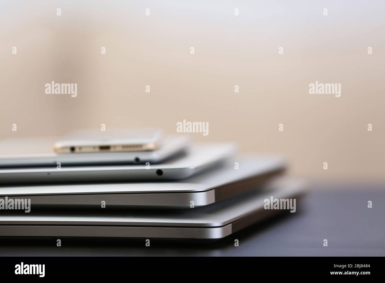 Stack of electronic devices on a dark desk Stock Photo - Alamy