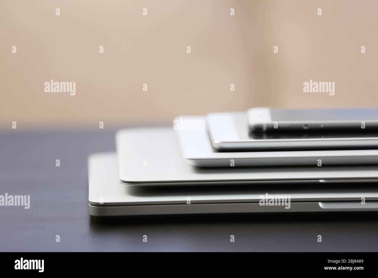 Stack of electronic devices on a dark desk Stock Photo - Alamy