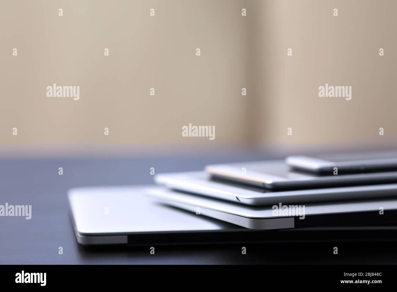 Stack of electronic devices on a dark desk Stock Photo - Alamy