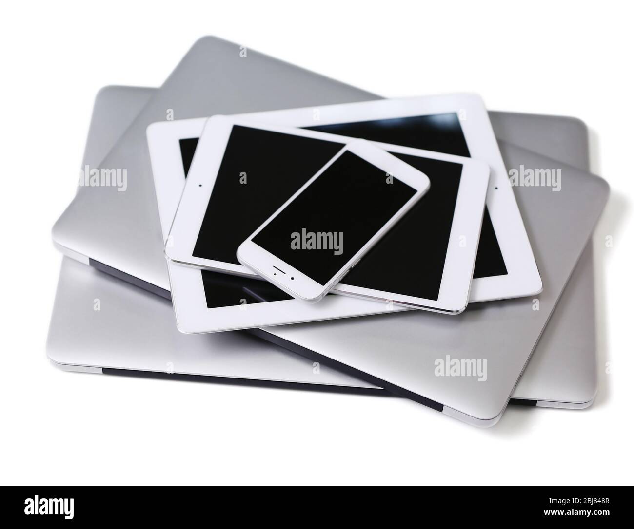 Stack of electronic devices on a white desk Stock Photo - Alamy