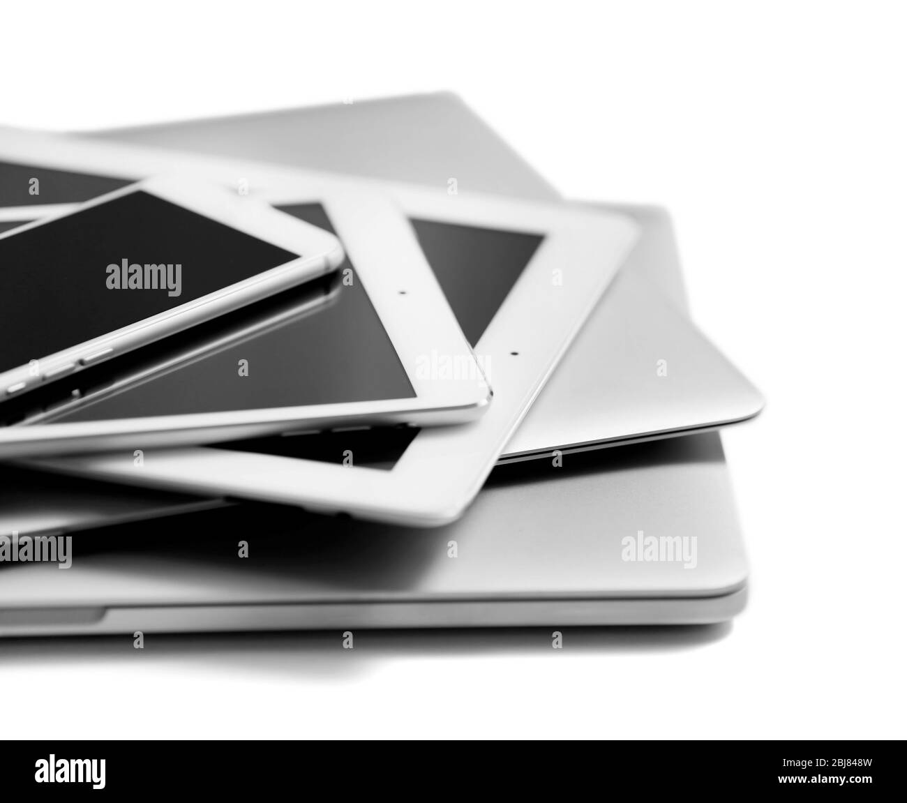 Stack of electronic devices on a white desk Stock Photo - Alamy