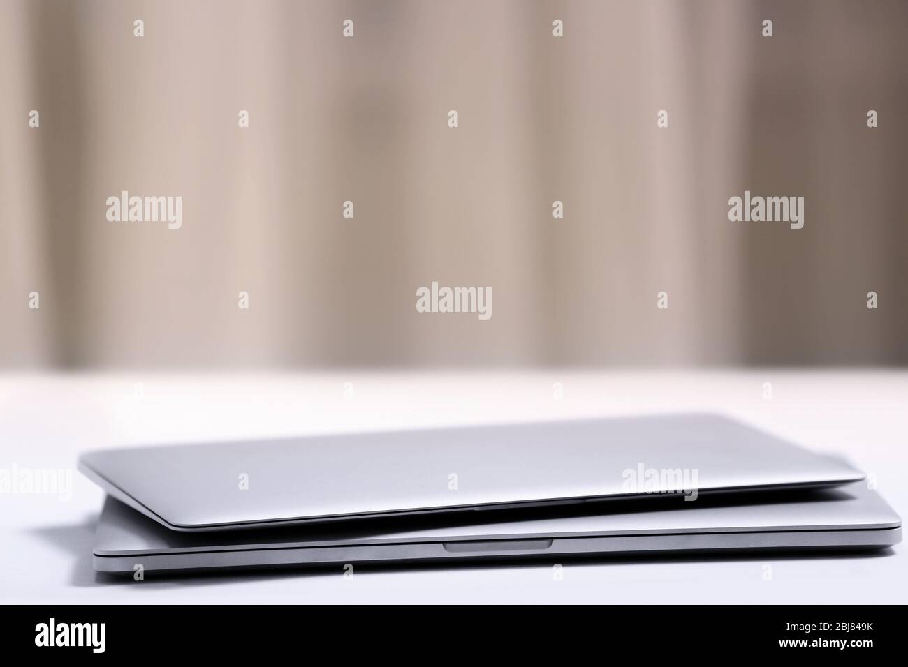 Two laptops on a white desk Stock Photo - Alamy