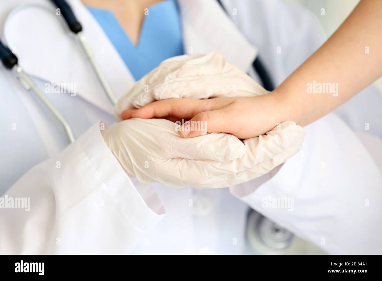 Doctor holding child's hand, closeup Stock Photo - Alamy