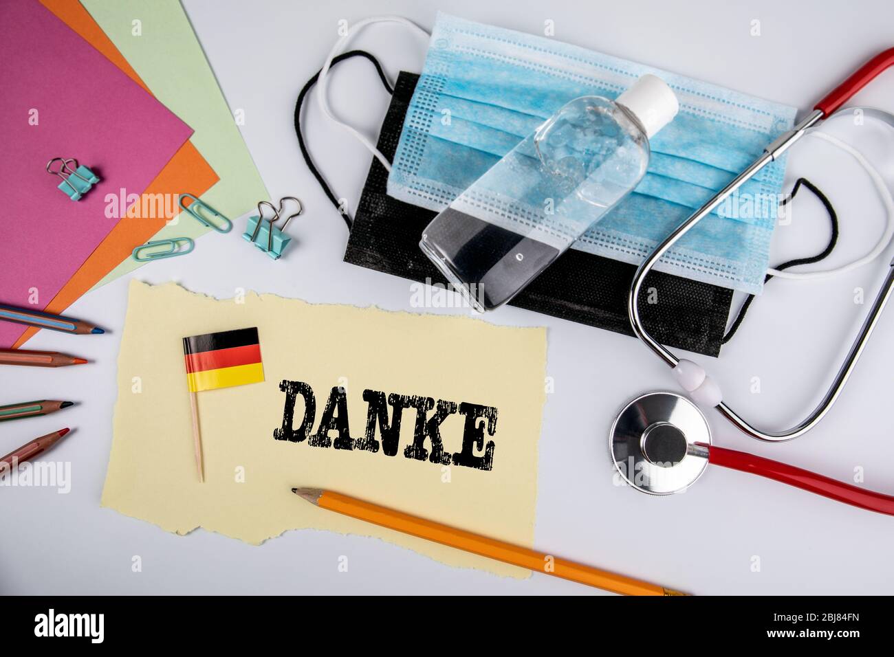 German Word Danke which means Thanks. Black and Blue Doctor mask, hand ...