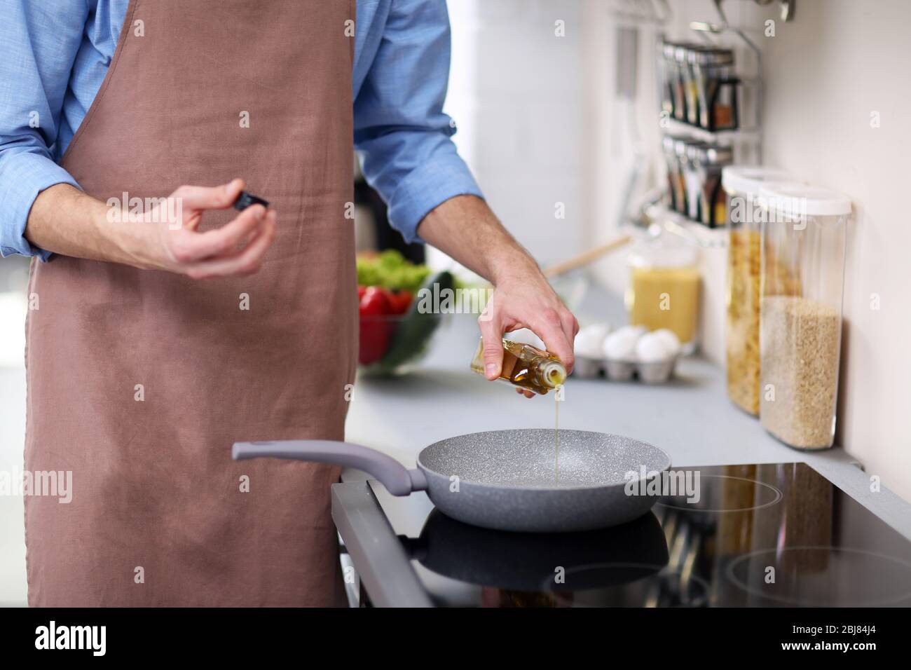 Man cooking in kitchen Stock Photo - Alamy