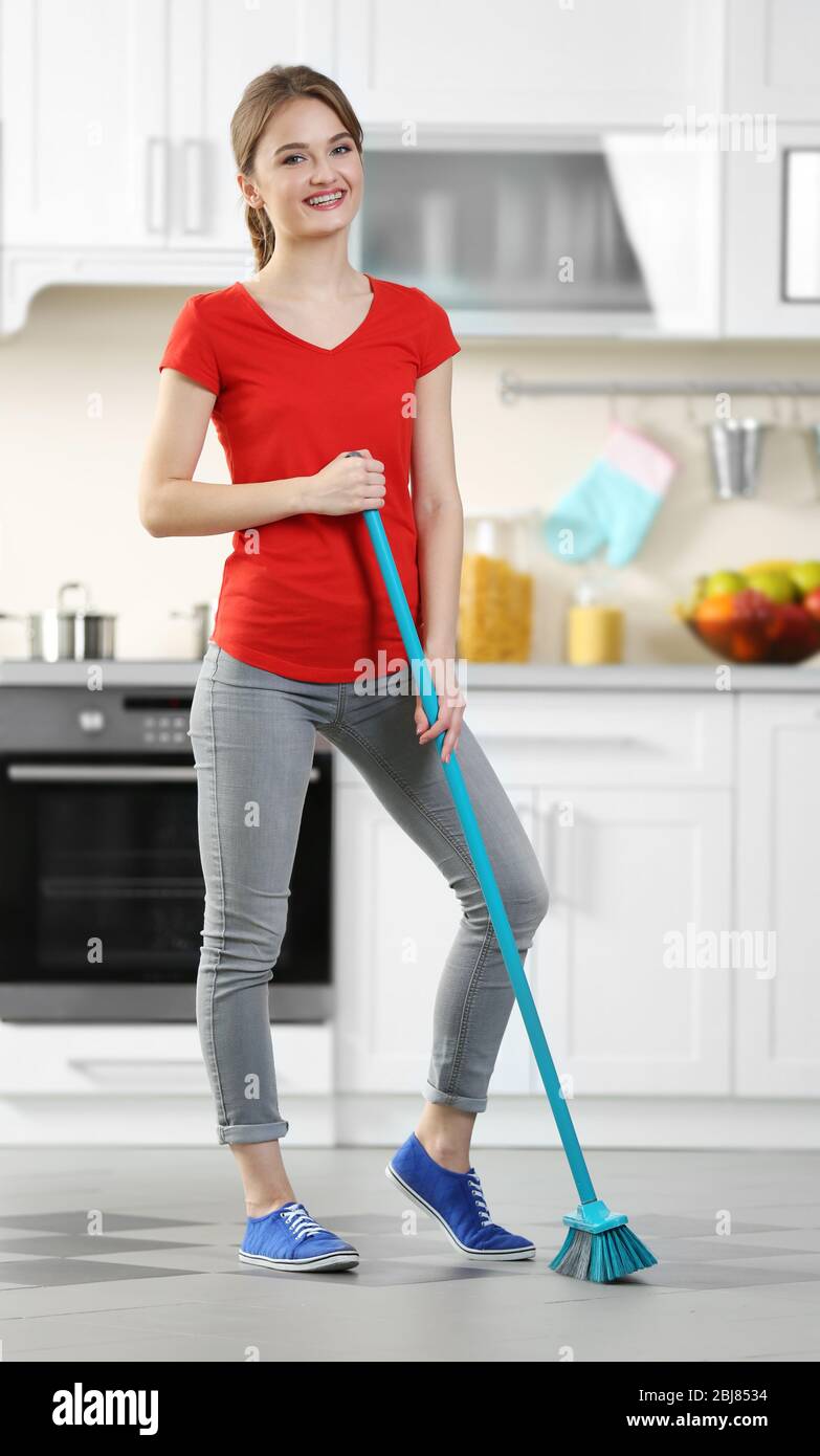 Cleaning concept. Young woman washing floor on the kitchen Stock Photo ...