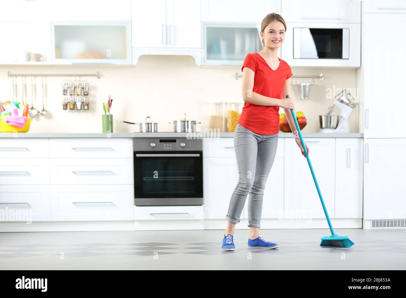 Cleaning concept. Young woman washing floor on the kitchen Stock Photo ...