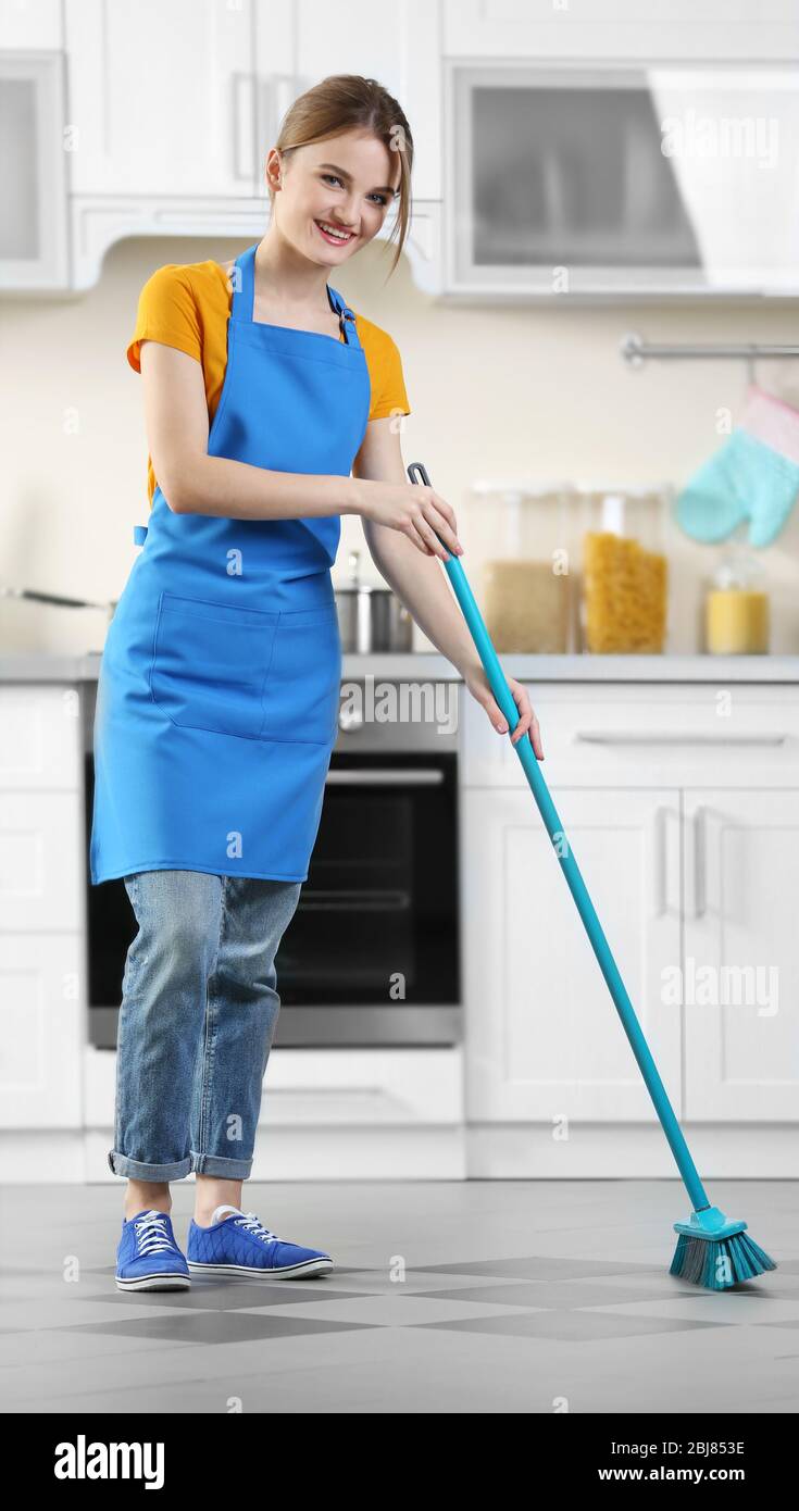 Cleaning concept. Young woman washing floor on the kitchen Stock Photo ...