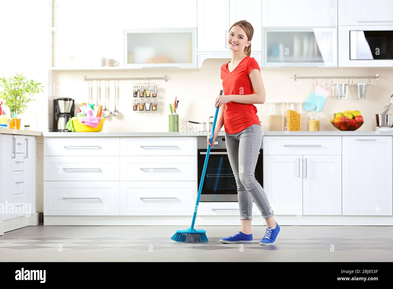 Cleaning concept. Young woman washing floor on the kitchen Stock Photo ...
