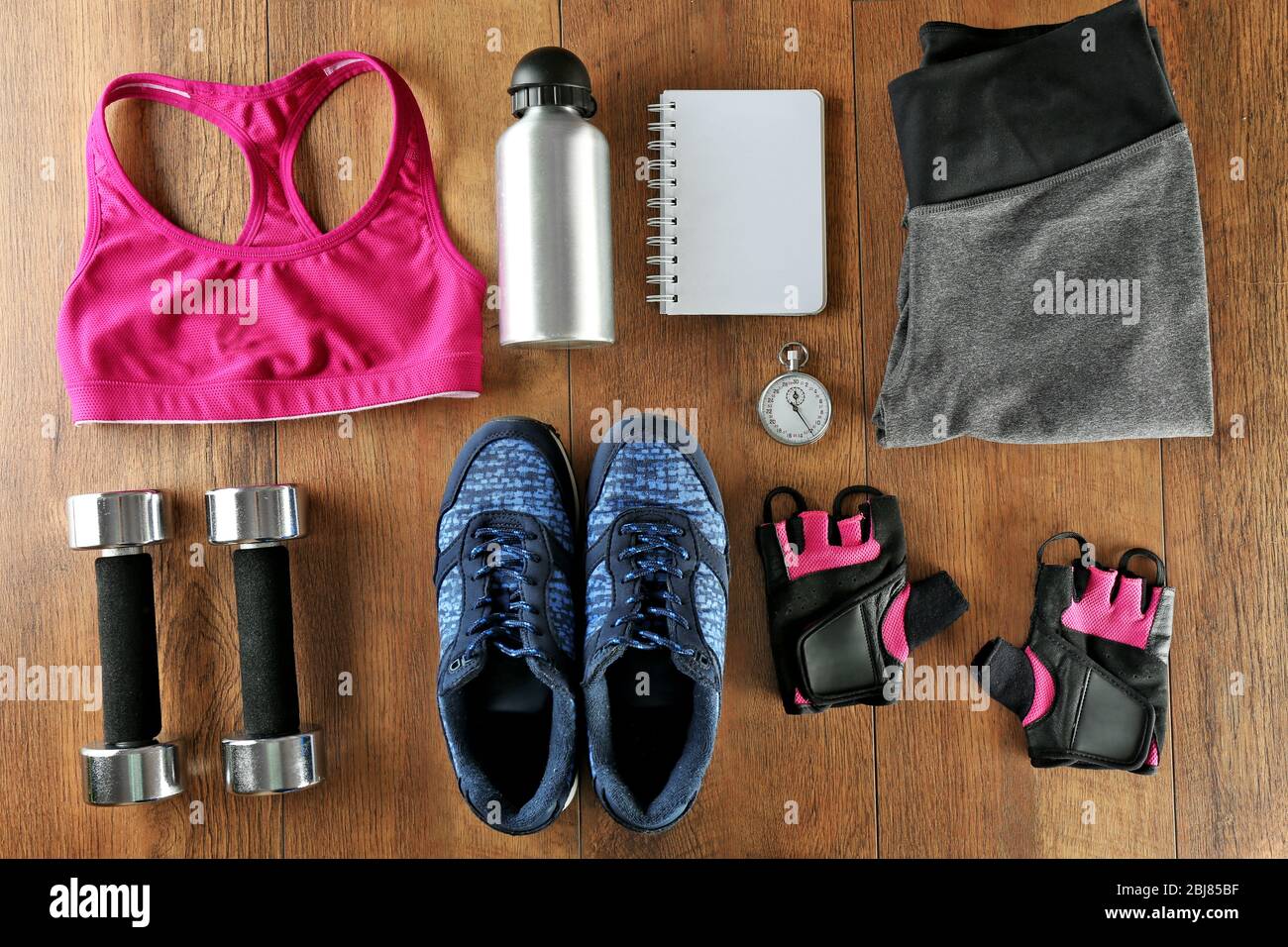 Athlete's set with female clothing, equipment, bottle of water and ...