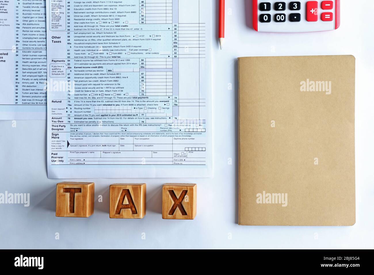 Individual income tax return, calculator and notebook on table Stock ...
