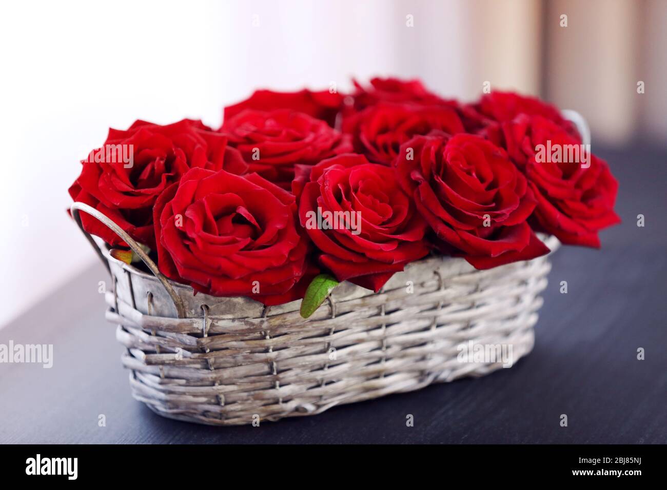 Red roses in basket on a table Stock Photo - Alamy