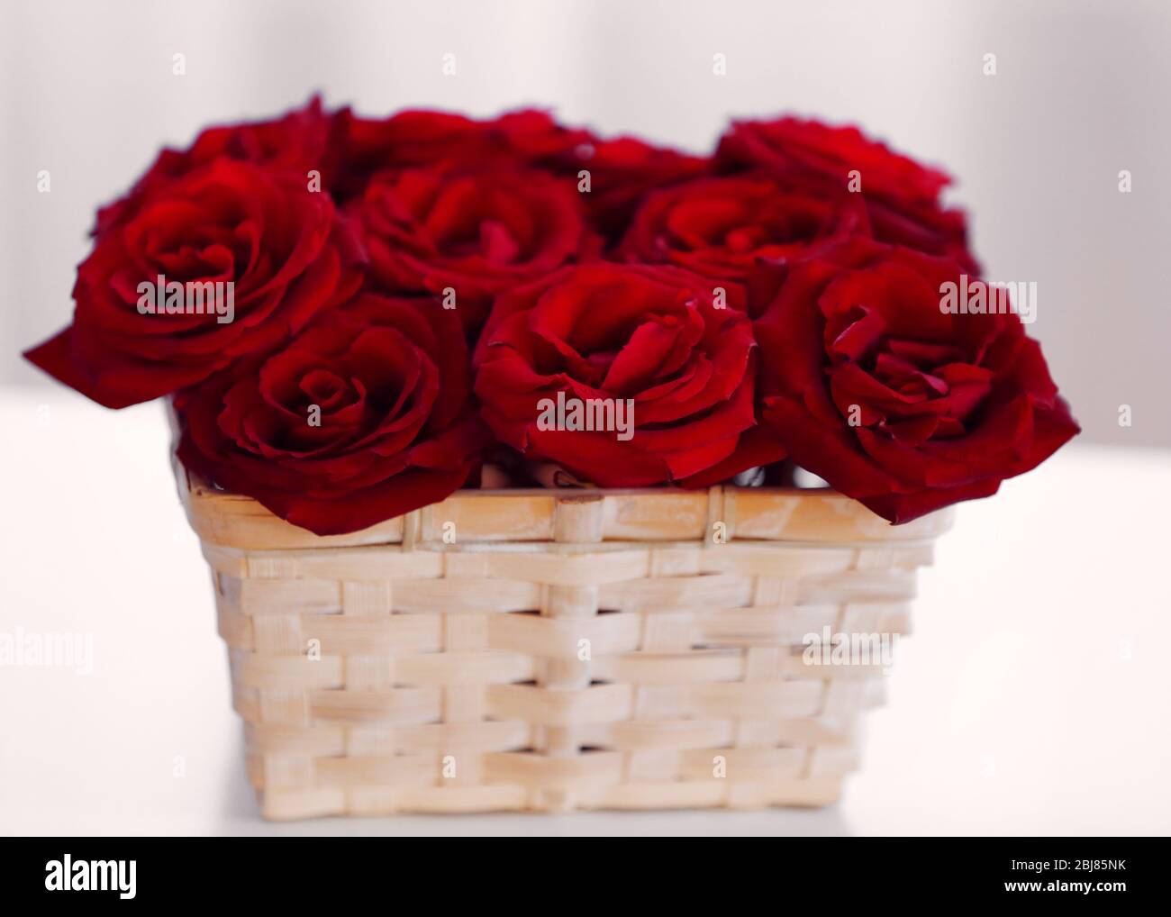 Red roses in basket on a table Stock Photo - Alamy