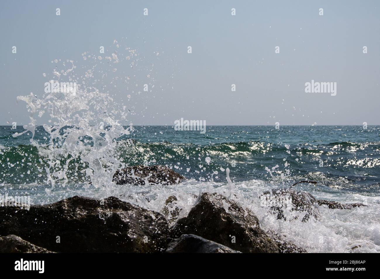 Beautiful wild beach landscape, sunny day, water waves hitting the ...