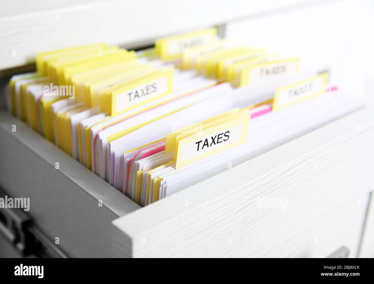 Open drawer with variety of tax documents Stock Photo - Alamy