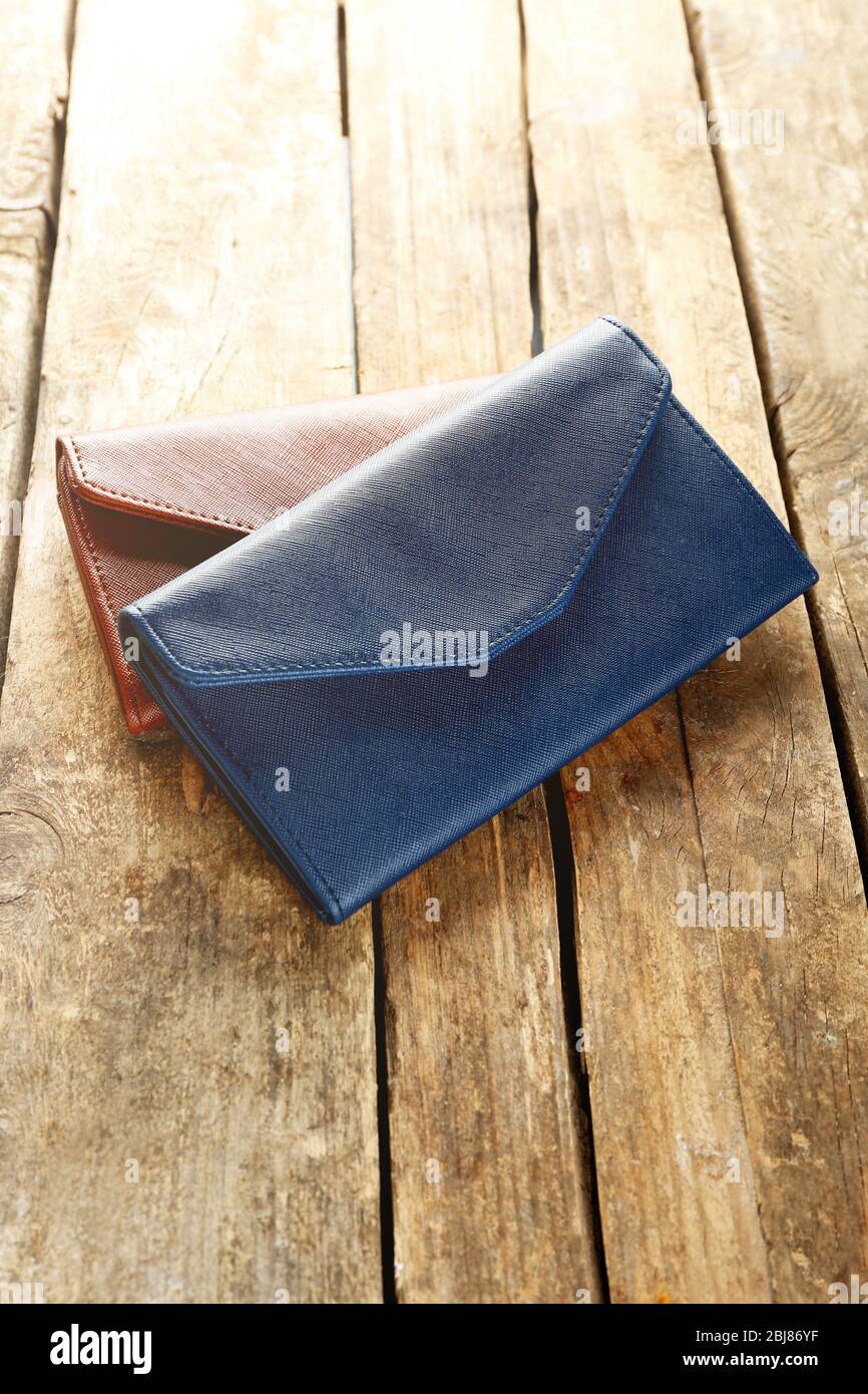 Leather wallets on wooden table Stock Photo - Alamy