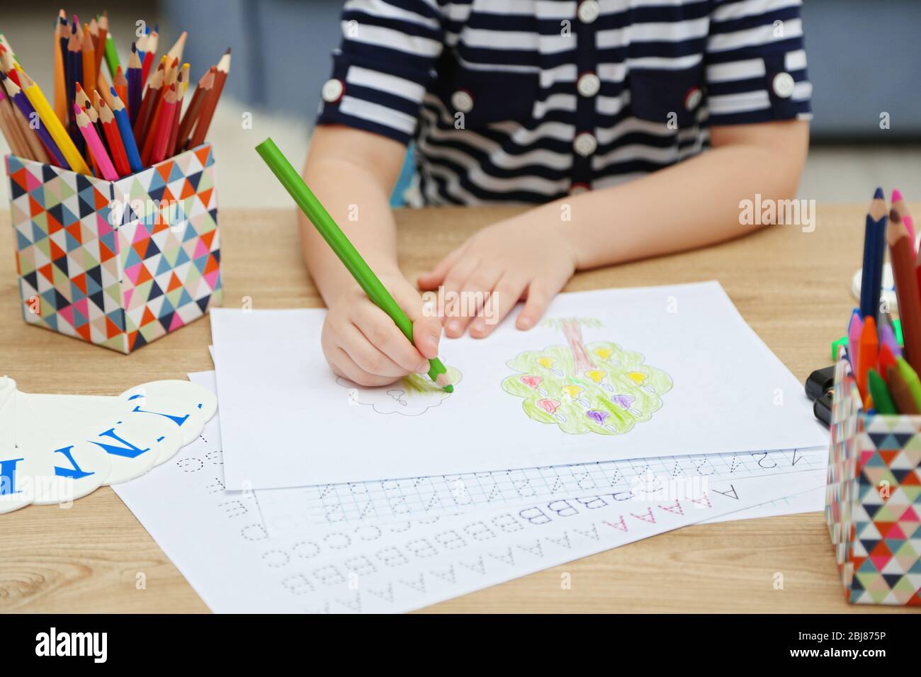 Little girl learning to draw at the table Stock Photo - Alamy