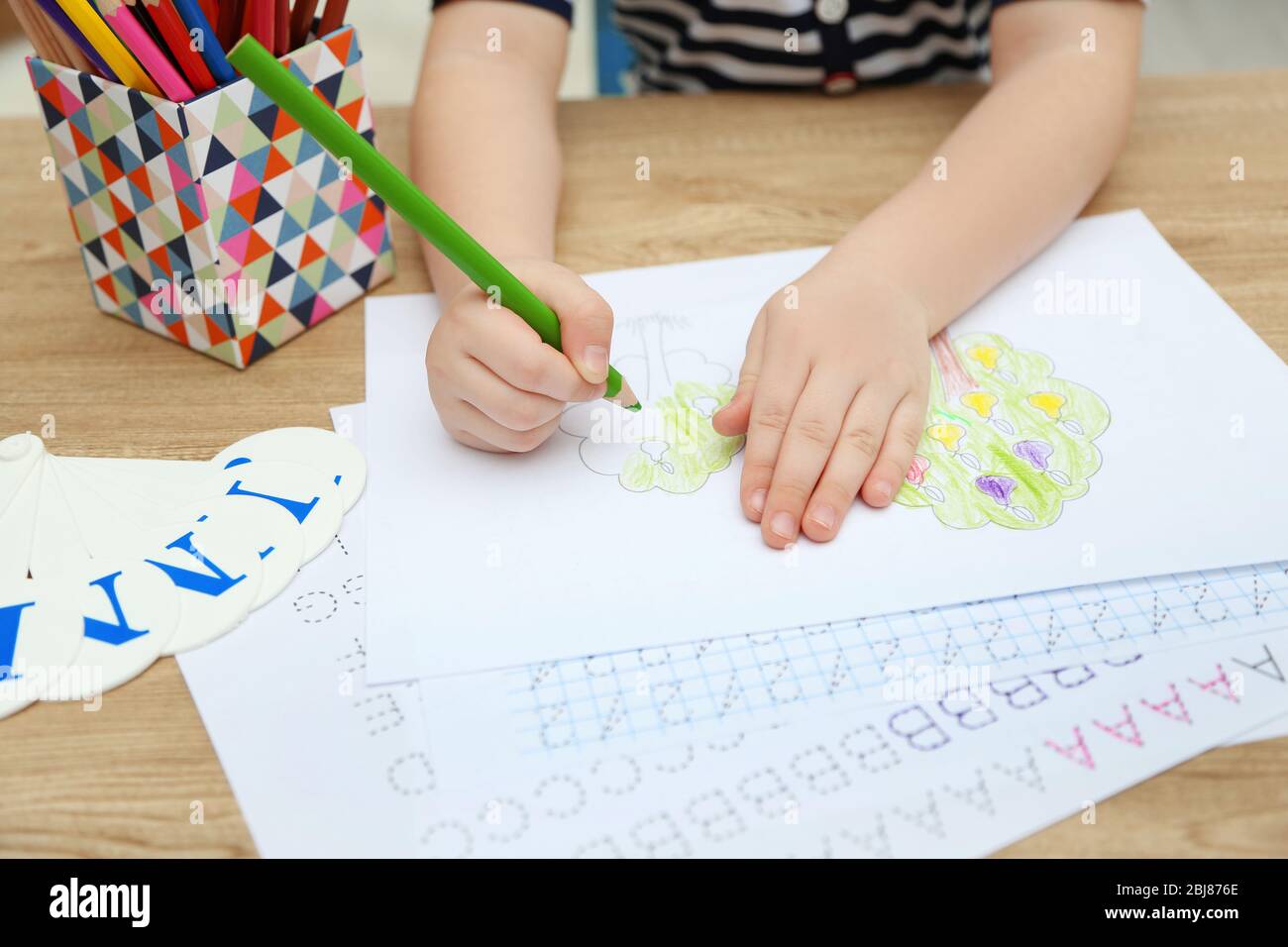 Little girl learning to draw at the table Stock Photo - Alamy