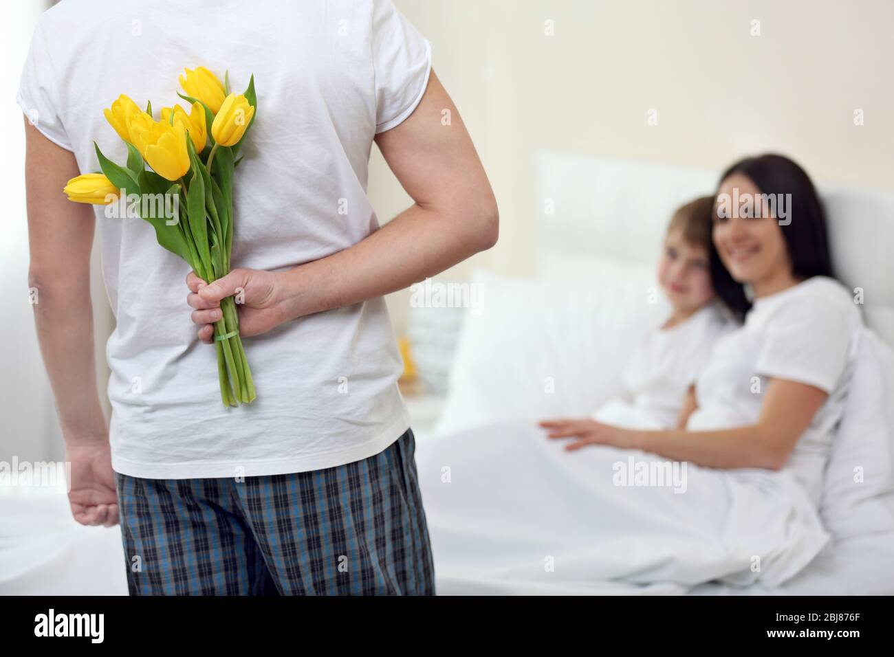 Husband hiding flower behind back hi-res stock photography and images ...