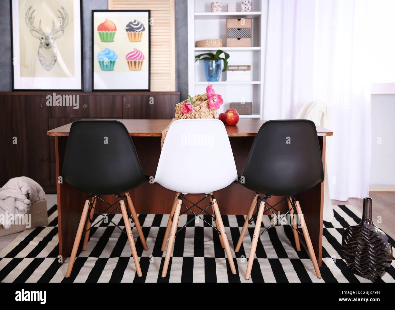Room interior with commode, table and chairs Stock Photo - Alamy