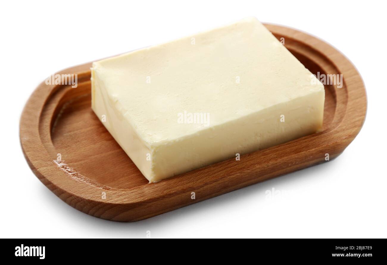 Piece of butter on wooden plate, closeup Stock Photo - Alamy