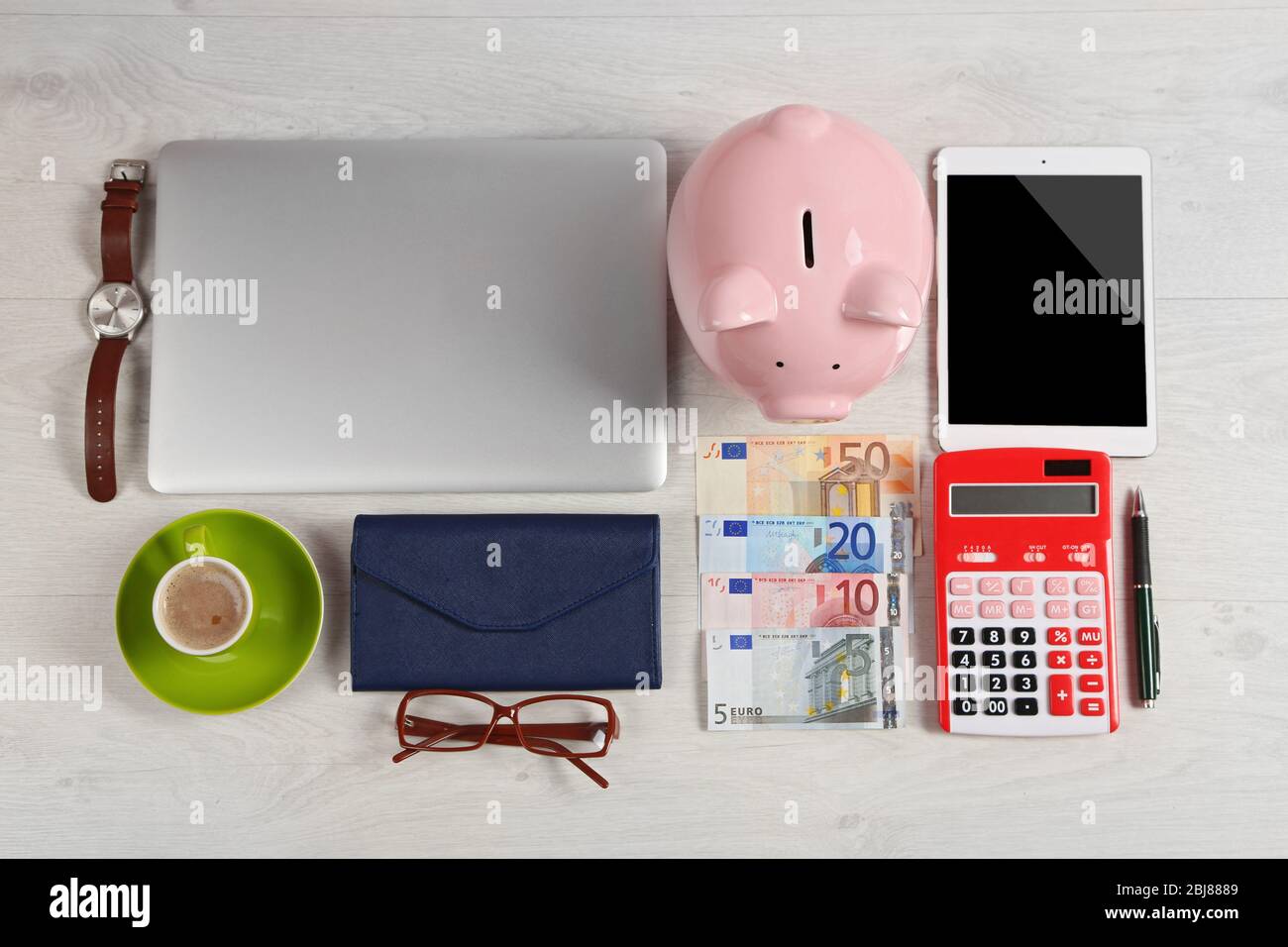 Piggy bank, office supplies and money on a white desk, top view Stock ...