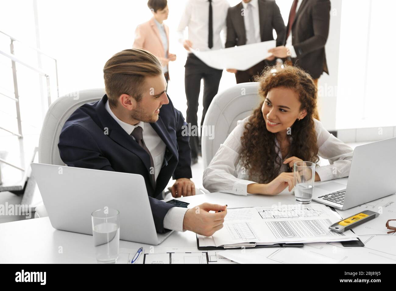 Team of professional engineers working with blueprints Stock Photo - Alamy