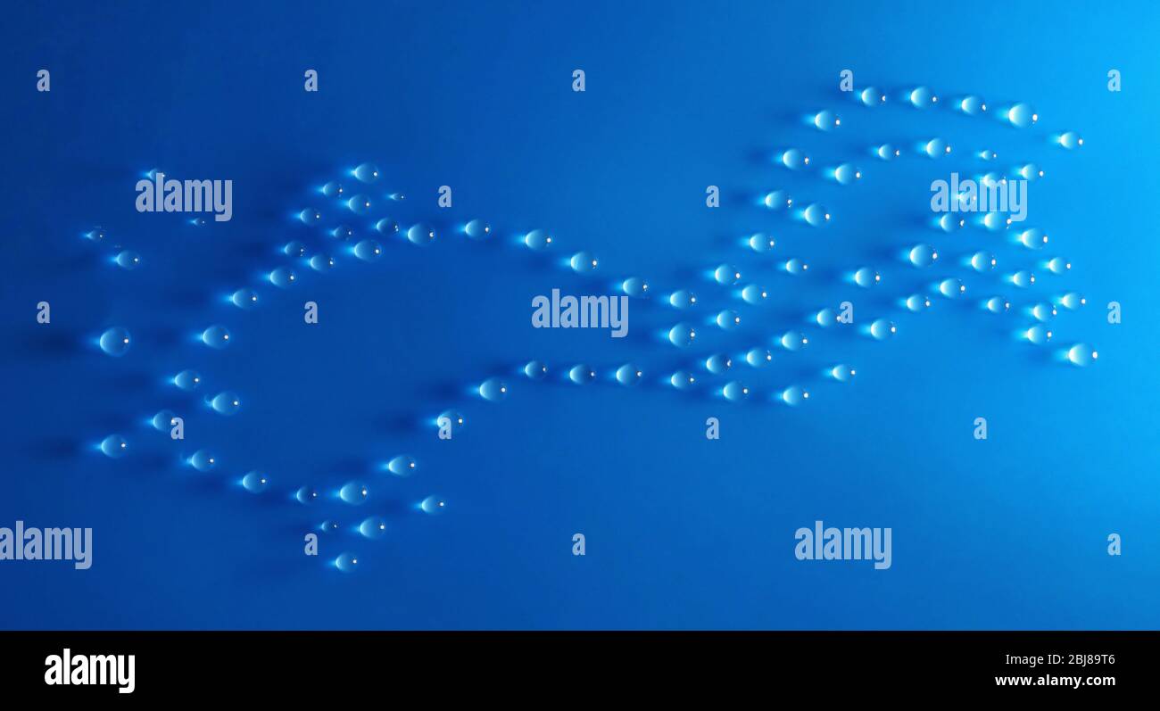 Fish made of water drops on blue background Stock Photo - Alamy