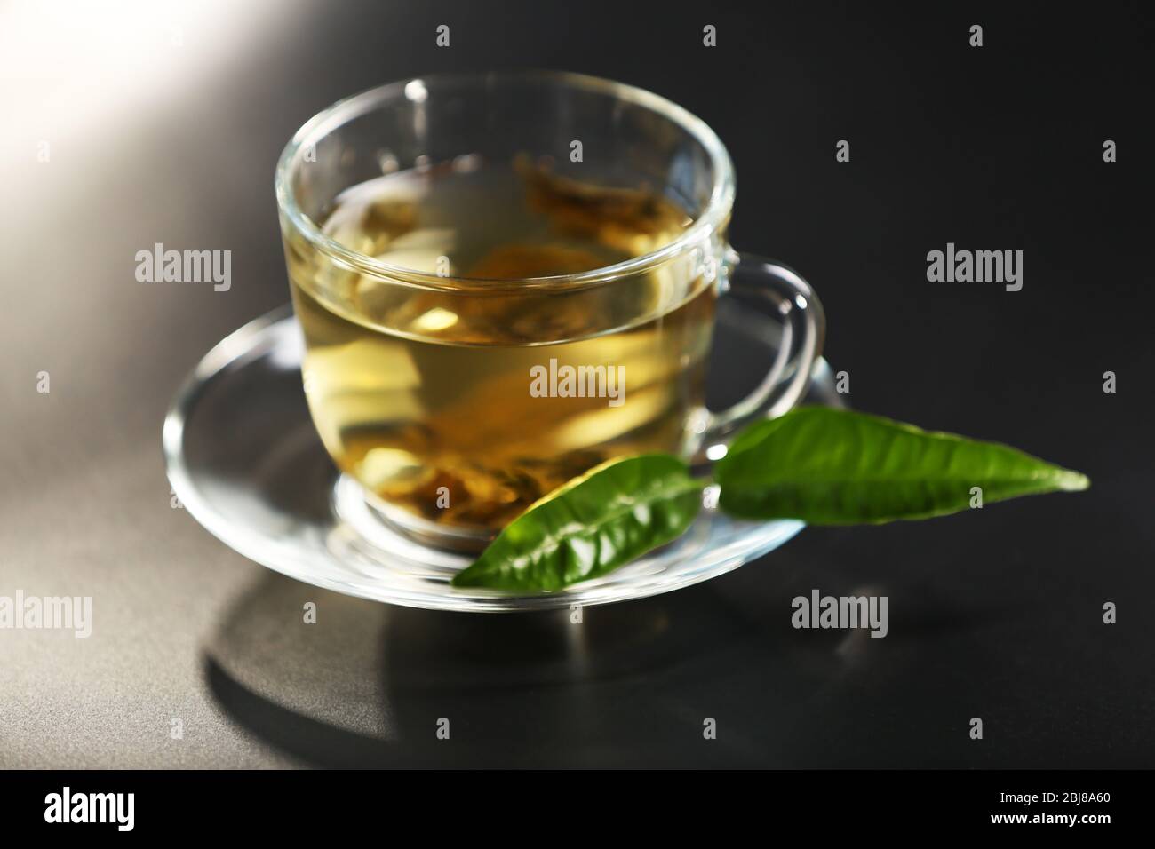 Cup of green tea on dark background Stock Photo - Alamy