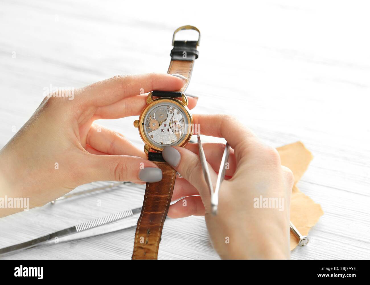 Watchmaker hands repairing mechanism of old watch closeup Stock Photo ...