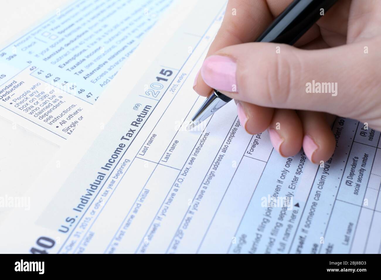 Female hand filling in the Income Tax Form, close up Stock Photo - Alamy