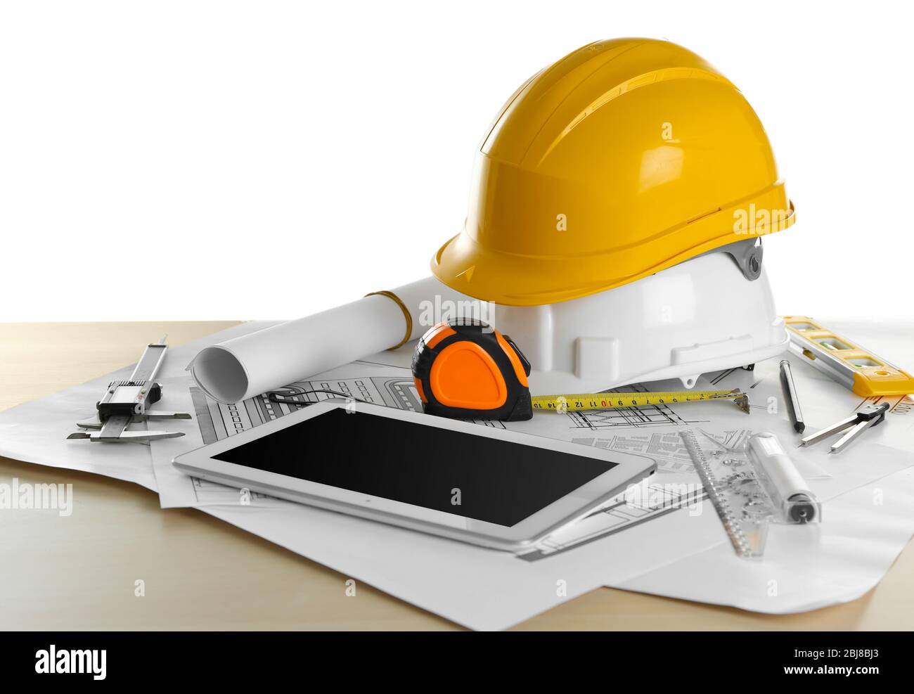 Table with construction drawings and other tools on white background ...