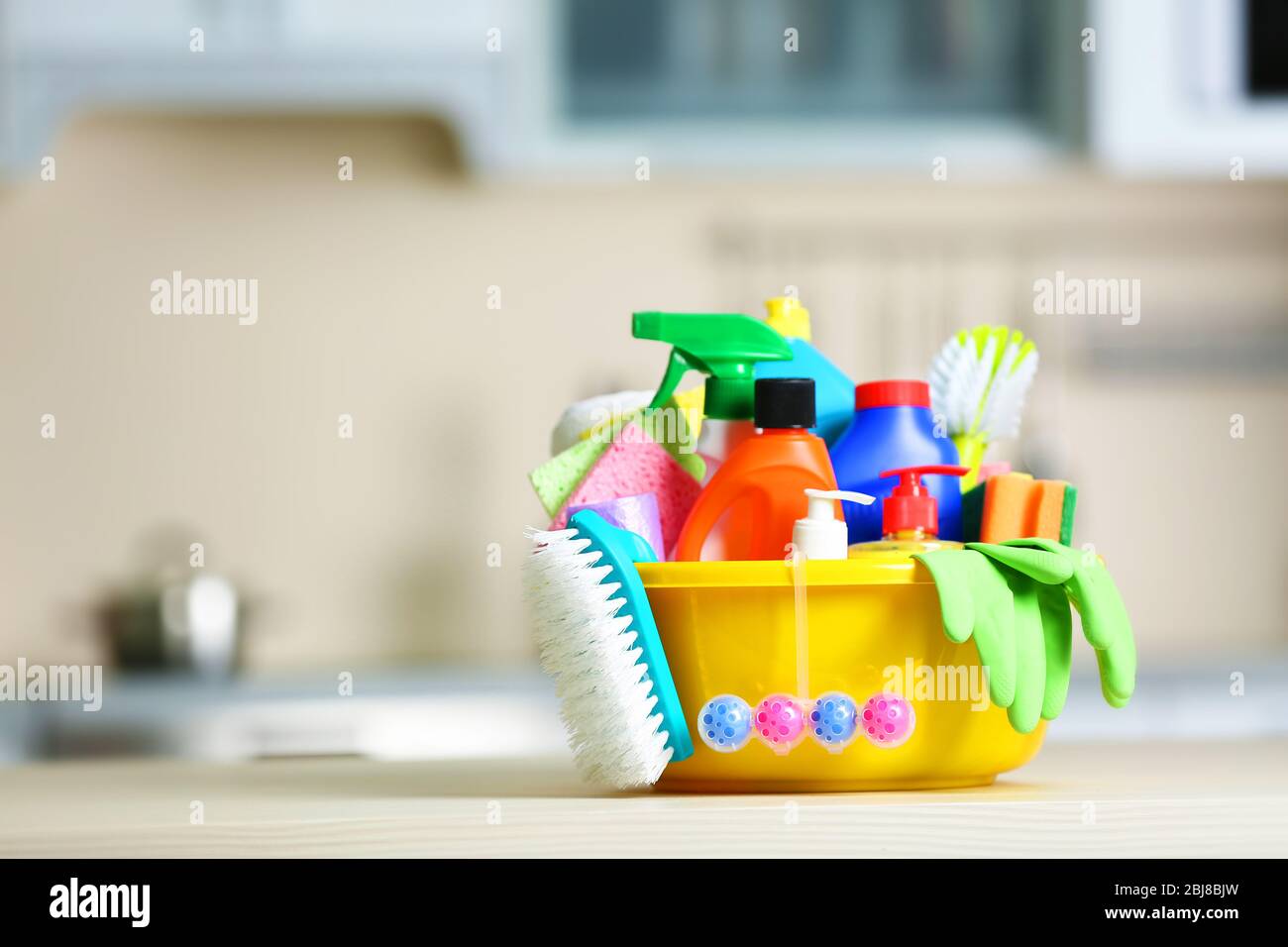 Cleaning set with products and tools in yellow tub Stock Photo - Alamy