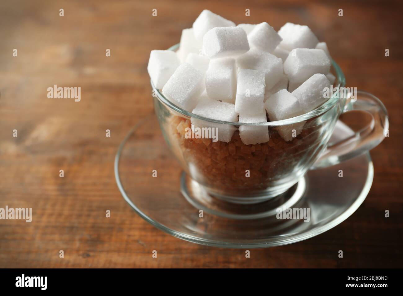 Glass cup with lump and brown sugar on wooden background Stock Photo ...