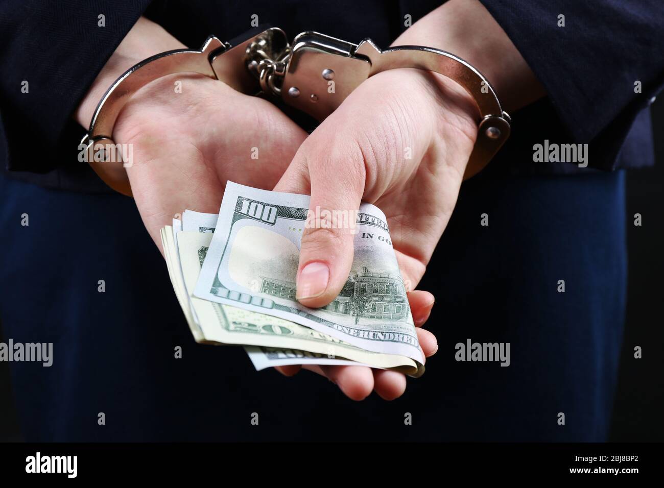 Man in handcuffs with money Stock Photo - Alamy