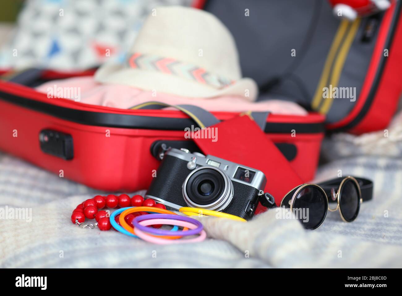 Woman's clothes in a red suitcase, close up Stock Photo - Alamy