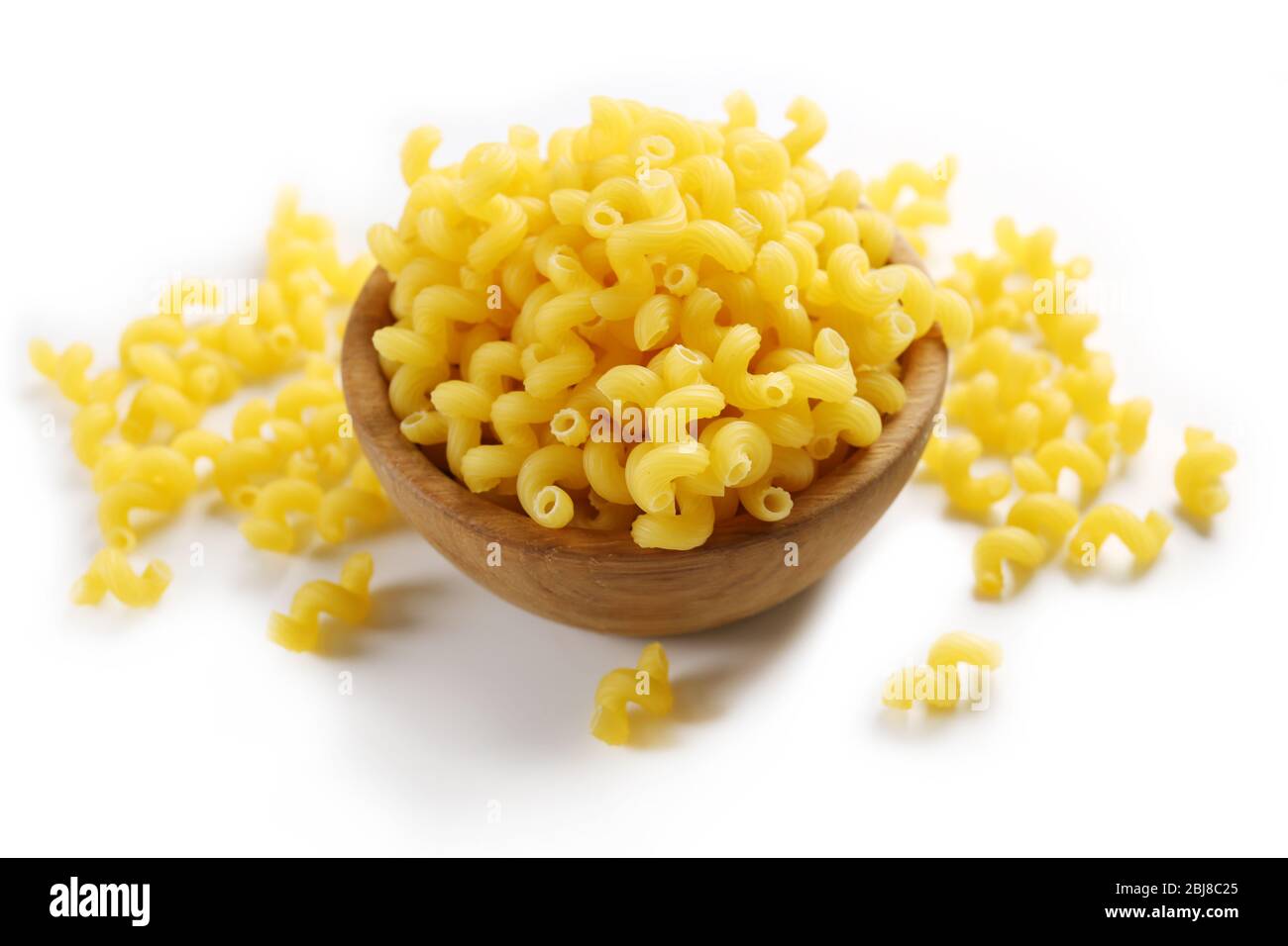 Italian dry pasta in a wooden bowl isolated on white Stock Photo - Alamy