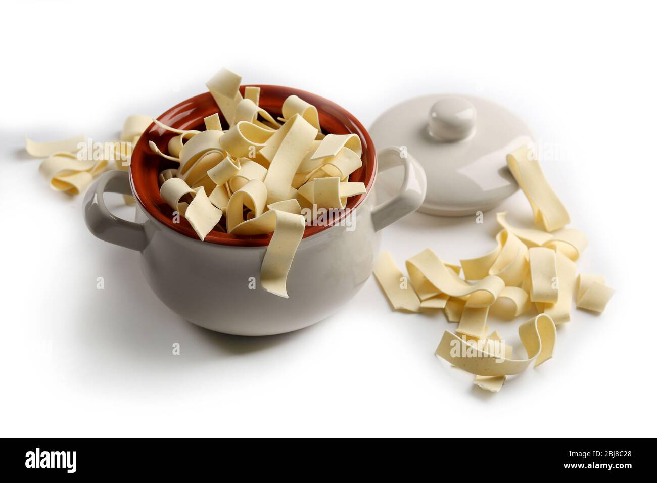 Dry pasta in a ceramic pot isolated on white, close up Stock Photo - Alamy