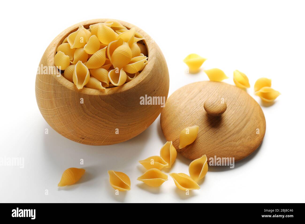 Italian dry pasta in a wooden pot, isolated on white Stock Photo - Alamy
