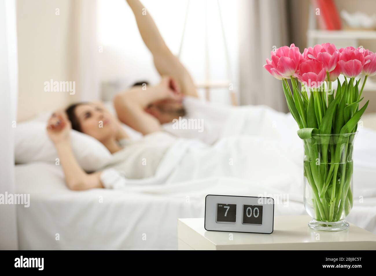 Young cute couple waking up after a night sleep Stock Photo - Alamy