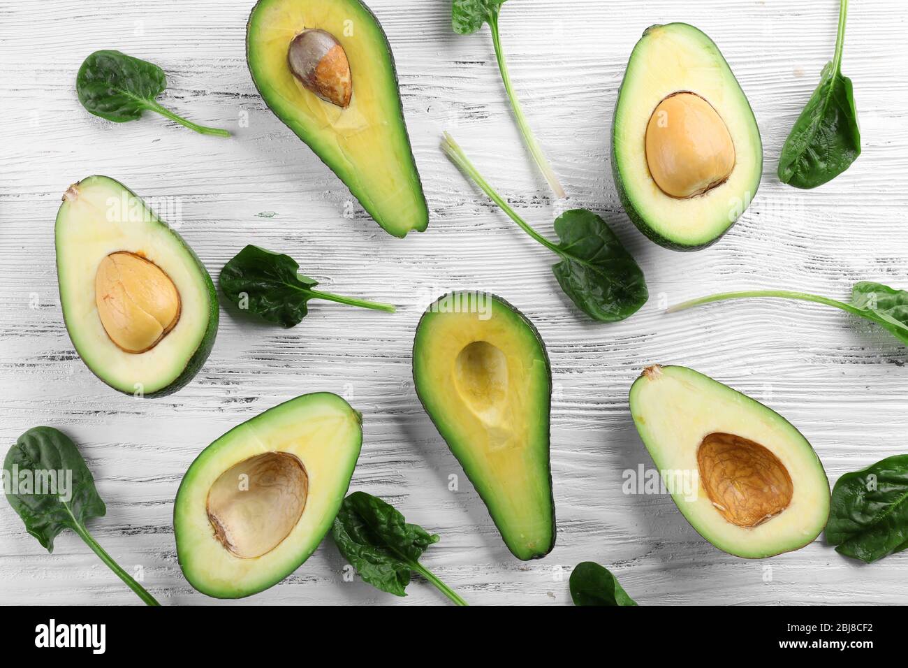 Avocado on a light wooden background Stock Photo - Alamy