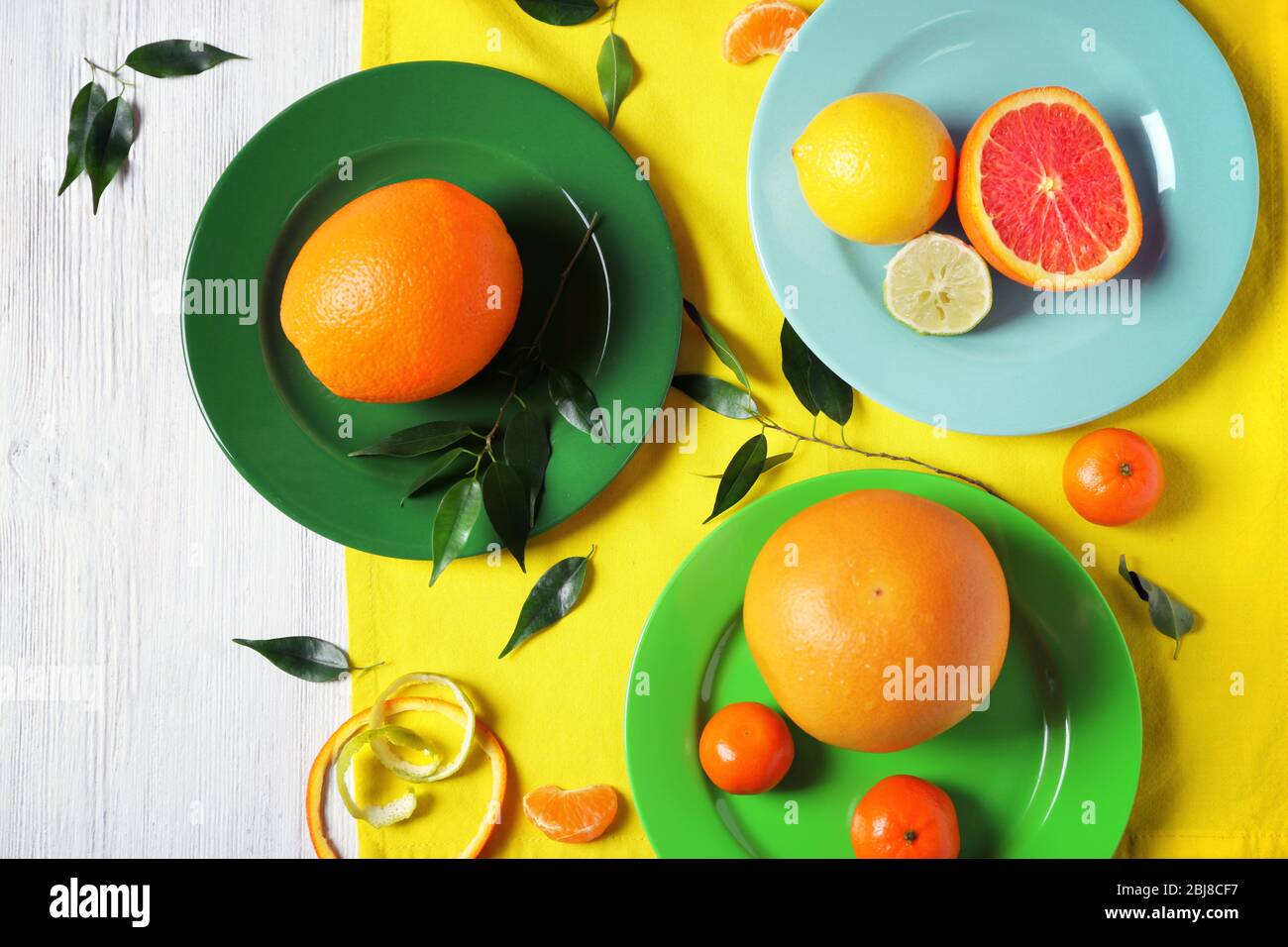 Citrus fruits on plates, closeup Stock Photo - Alamy