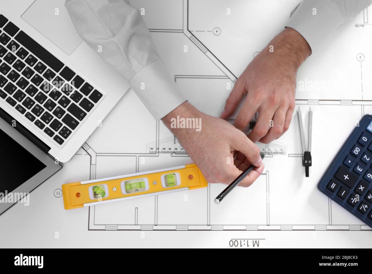 Professional engineer working with blueprints Stock Photo - Alamy