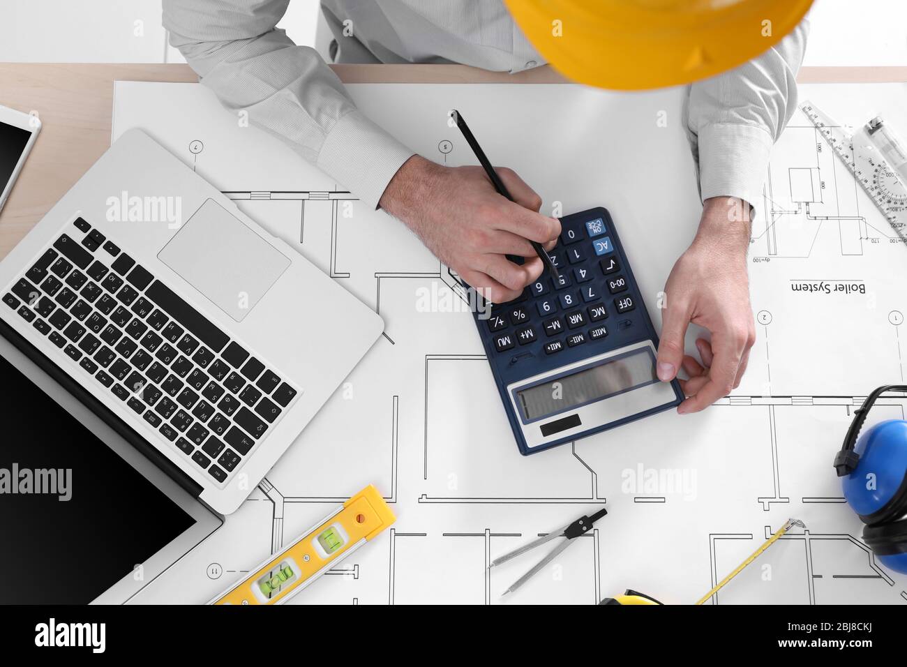 Professional engineer working with blueprints Stock Photo - Alamy