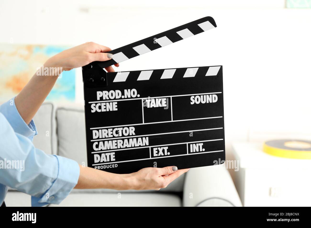 Woman holding black clapperboard movie hi-res stock photography and ...
